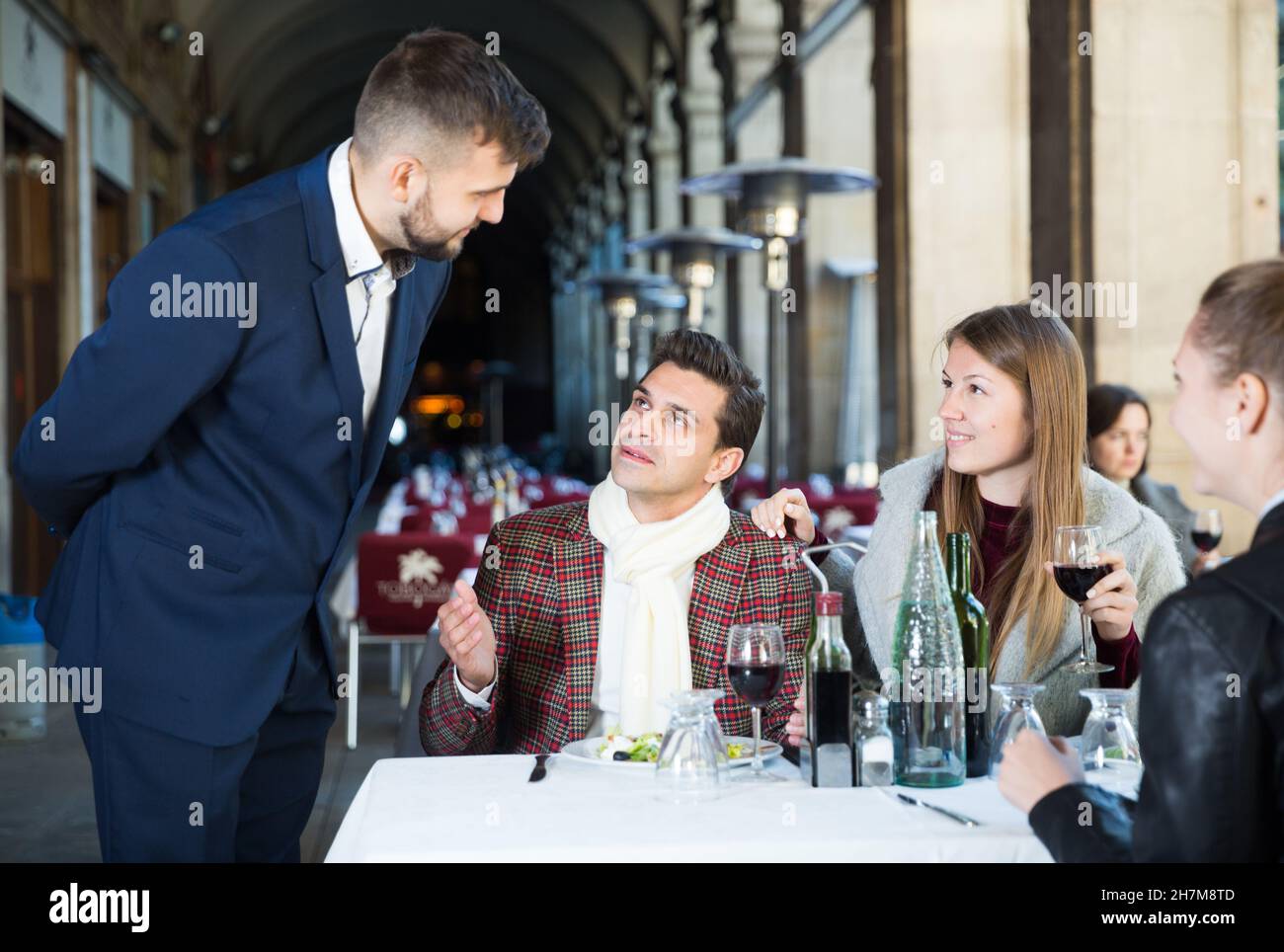 Positive company with restaurant manager Stock Photo - Alamy