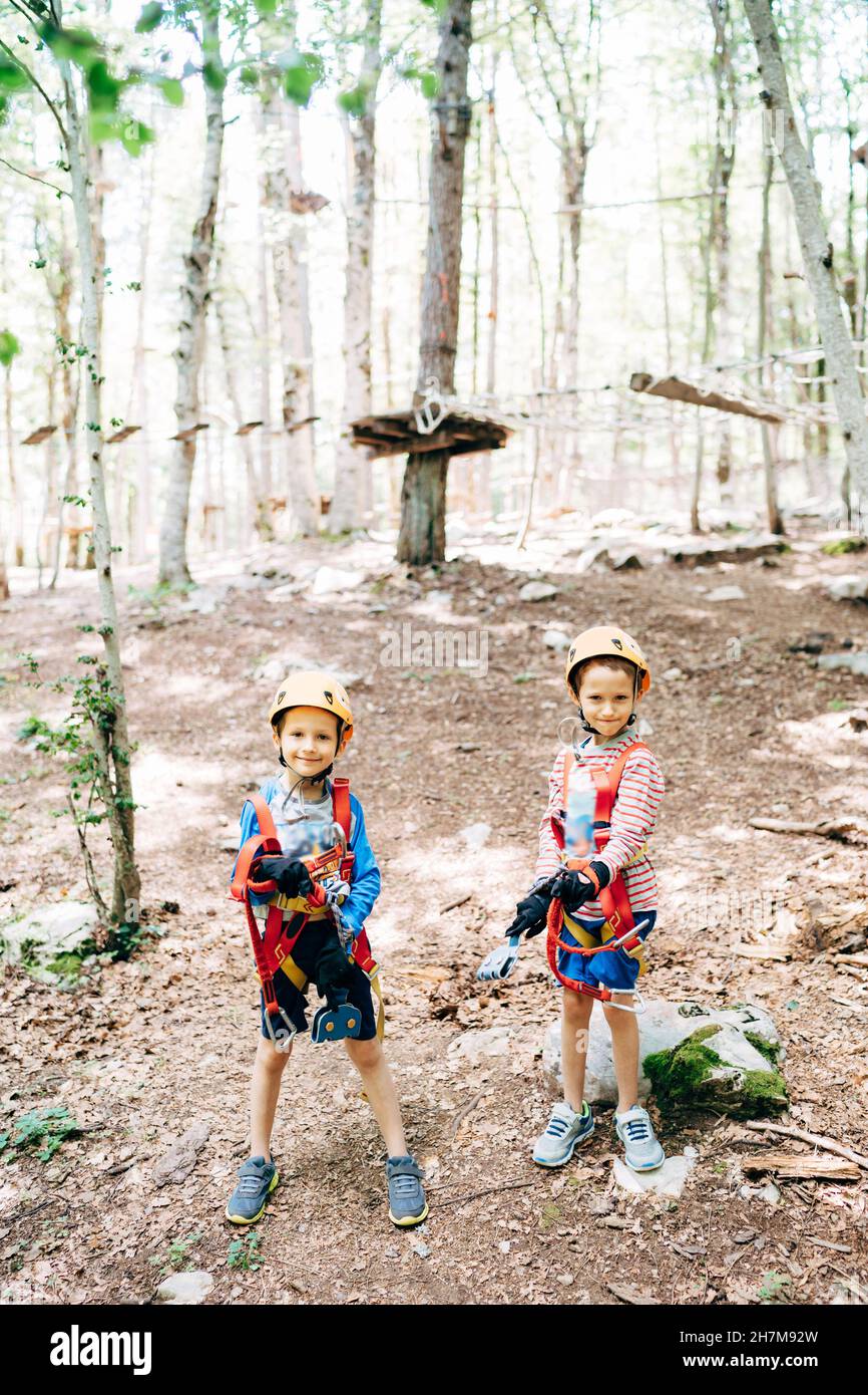 Boys are standing on the ground in an adventure park Stock Photo - Alamy