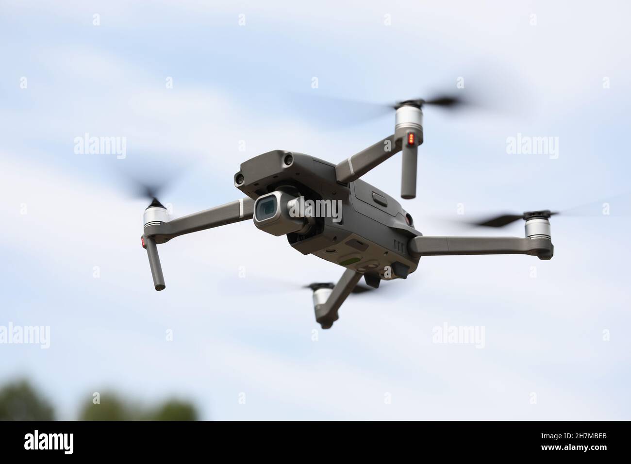 Modern drone device with remote controller flying and filming in air ...