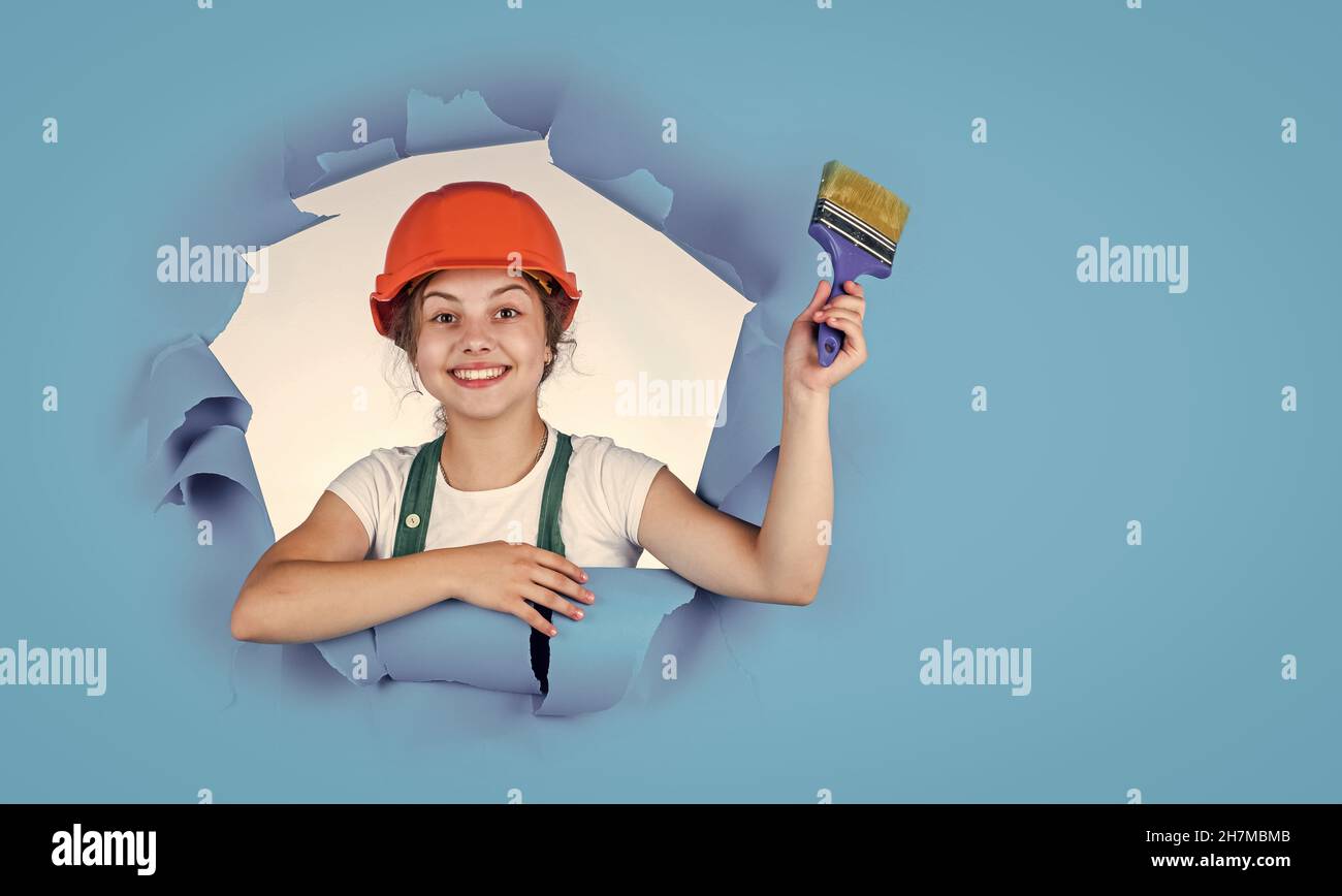 girl in protective helmet painting the wall. childhood development. Kid ...