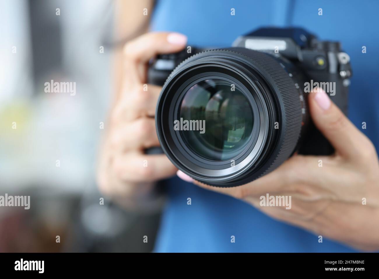 Professional woman photographer hold modern model of camera Stock Photo ...