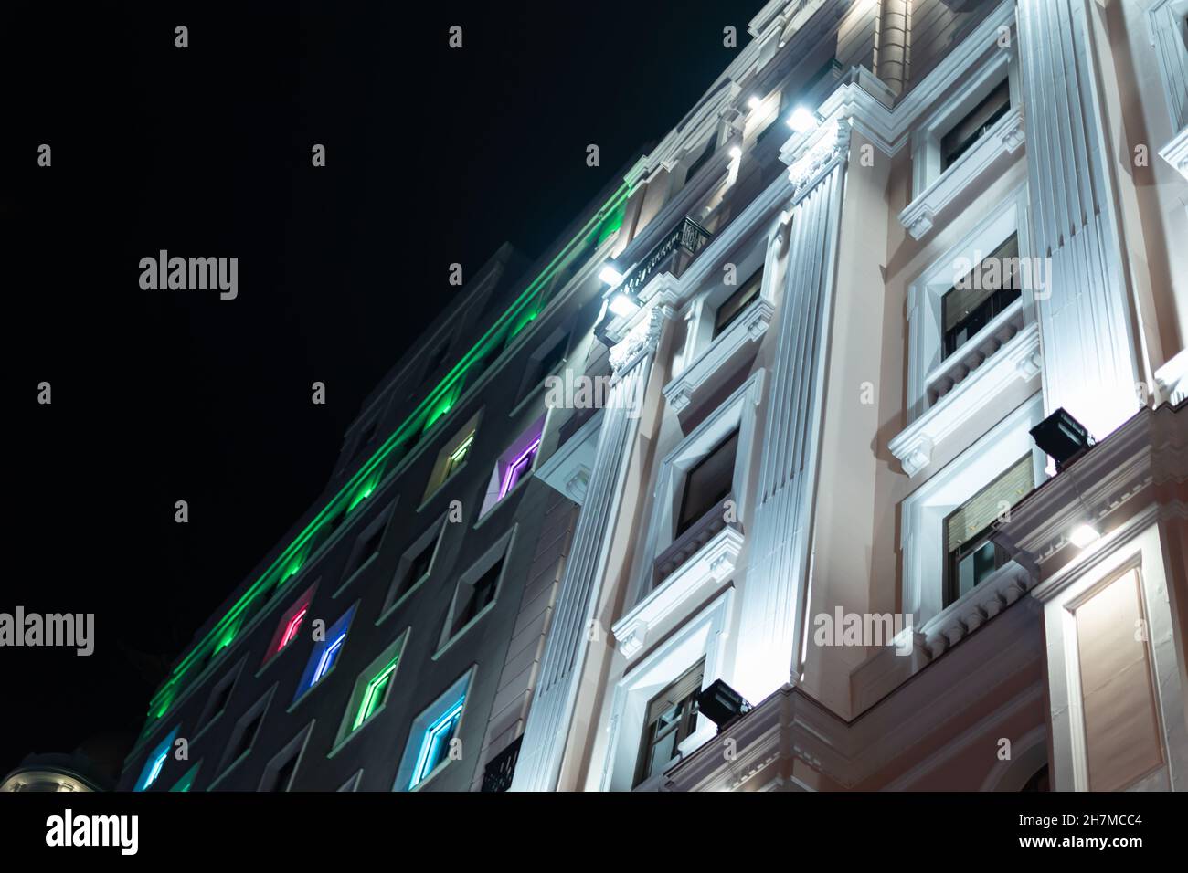 Night view building facade with colored lights on Gran Via in Madrid ...