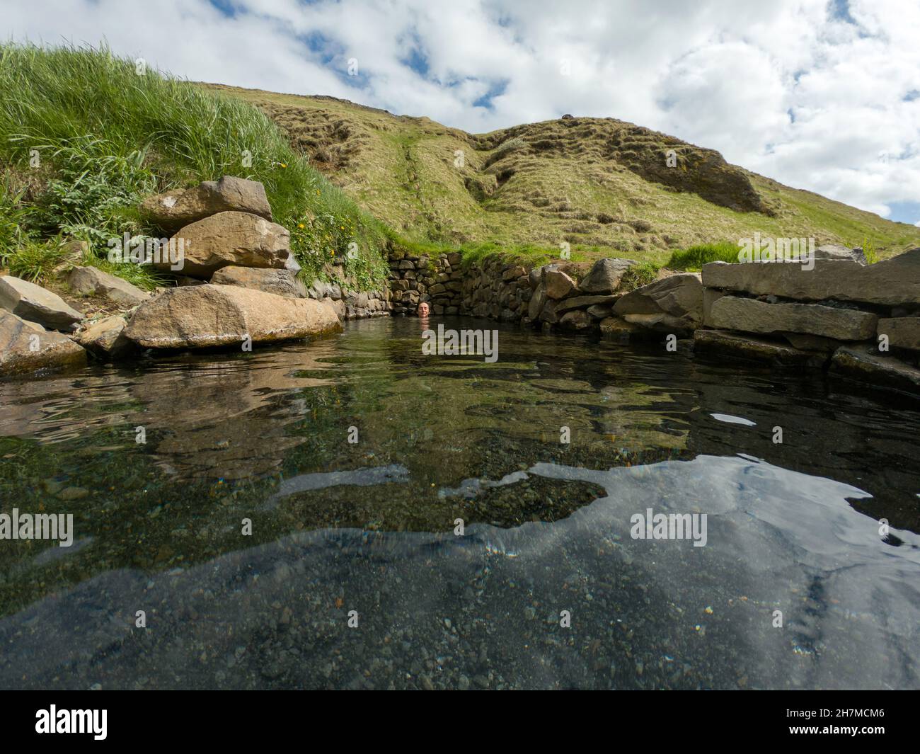 Woman relaxing in a hot spring pool in Hrunalaug, Iceland Stock Photo ...