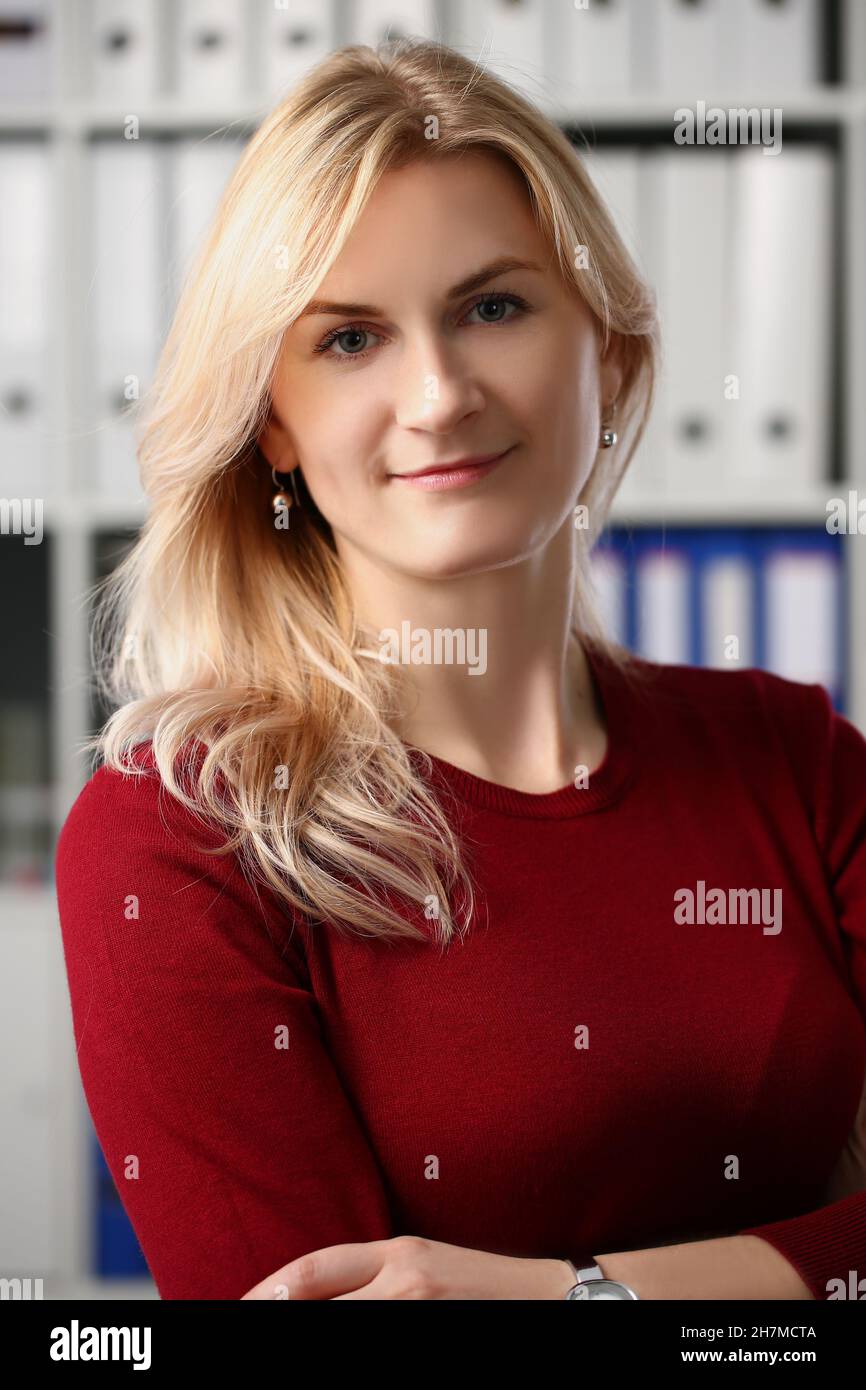 Presentable office worker smiling and posing for picture with crossed ...