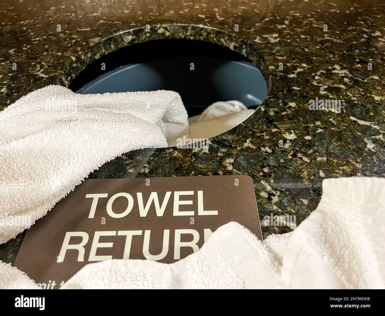 A used white towel on a granite towel return Stock Photo - Alamy