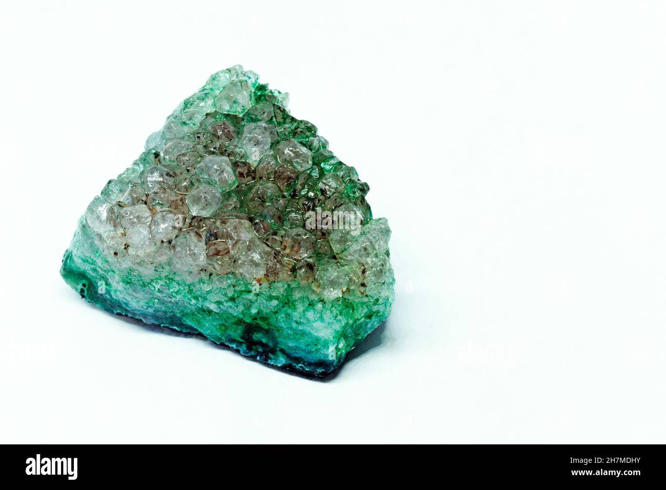 wet green stone with crystals on white background Stock Photo - Alamy