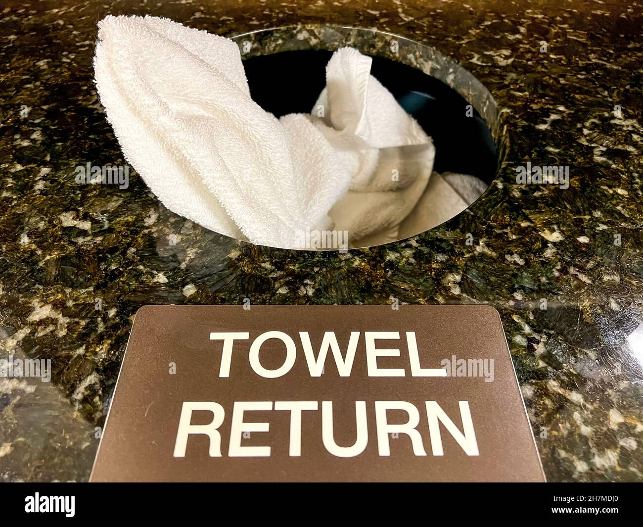 A used white towel on a granite towel return Stock Photo - Alamy