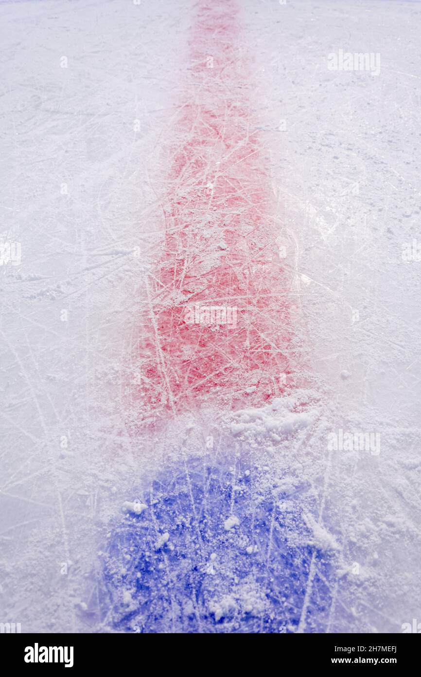 Ice of hockey rink cut by skates. Center face-off circle and red marker ...