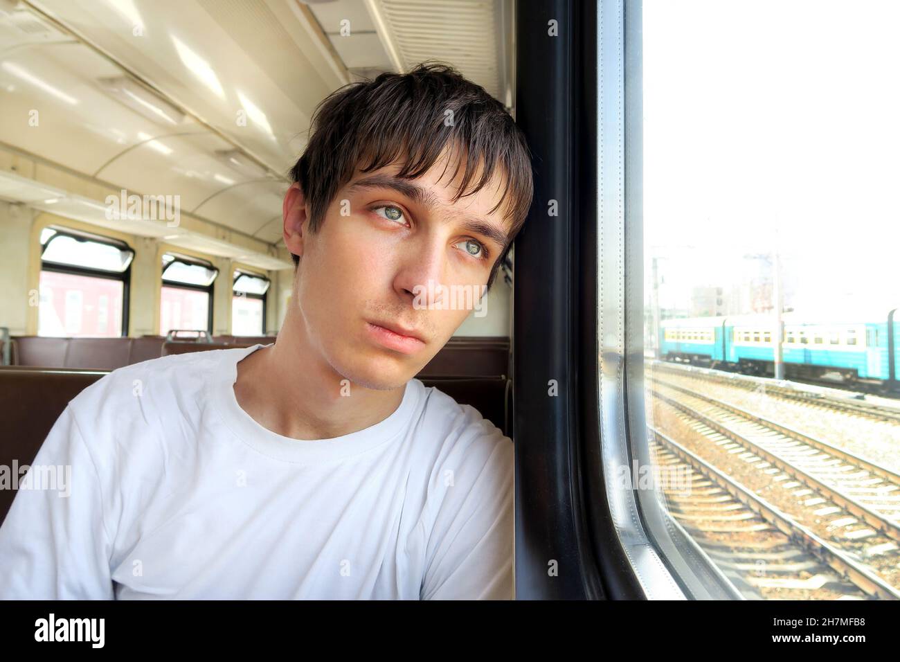 Sad Young Man in the Electric Train Stock Photo - Alamy