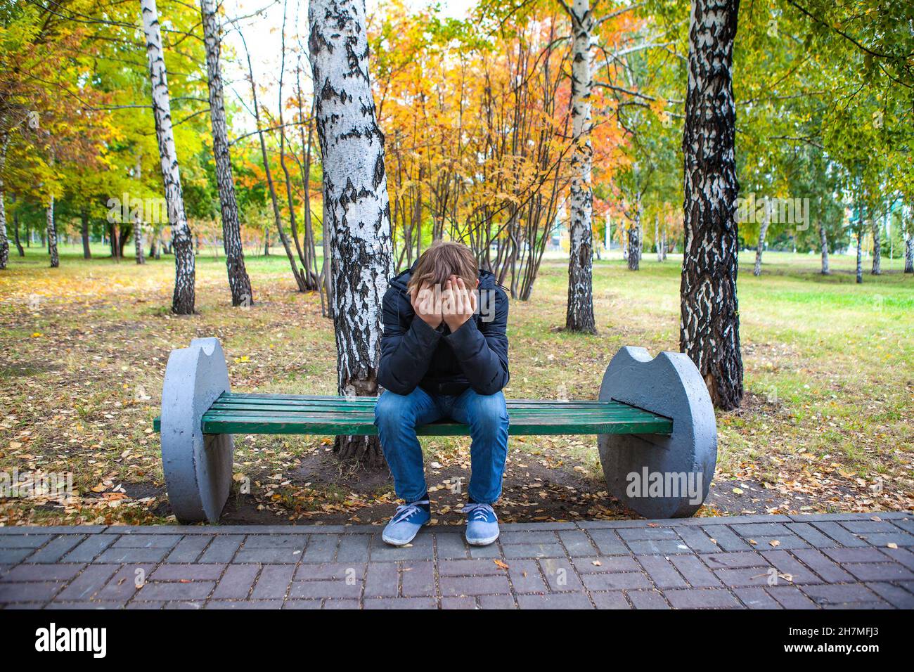 Stressed Teenager sit on the Bench in the Autumn Park Stock Photo - Alamy