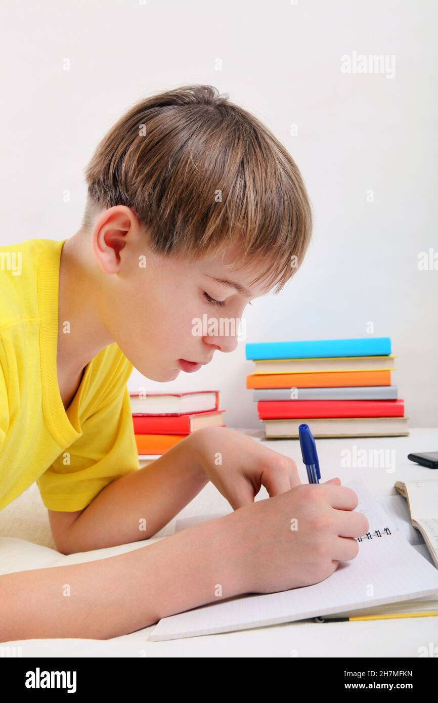Teen doing homework on bed hi-res stock photography and images - Alamy