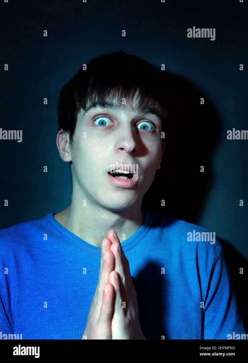 Toned Photo of Frightened Young Man in the Dark Room Stock Photo - Alamy
