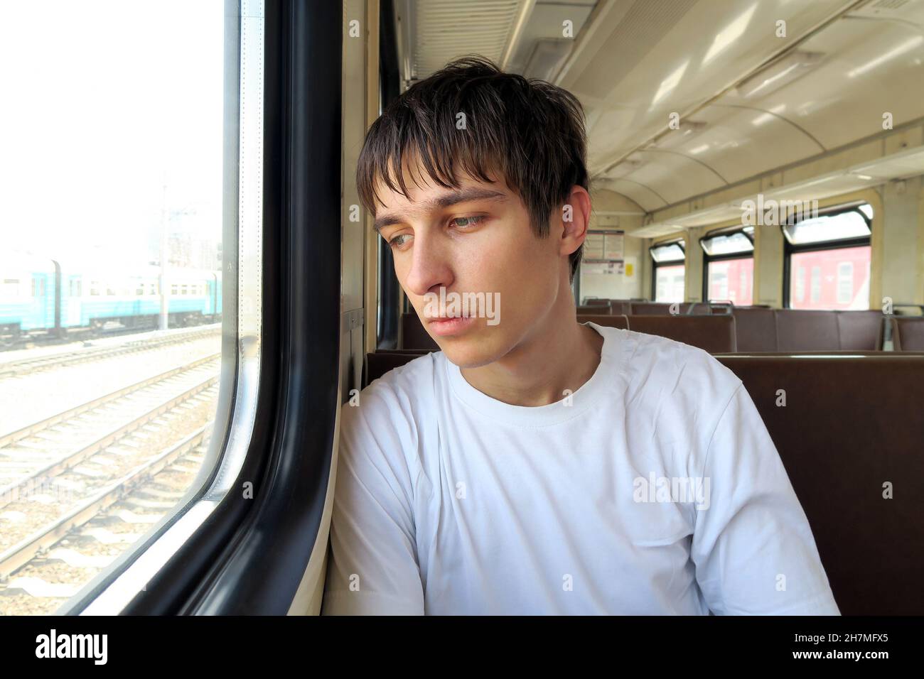 Sad Young Man in the Electric Train Stock Photo - Alamy