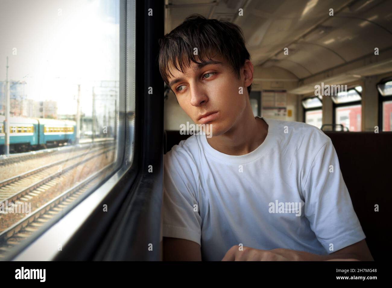 Sad Young Man in the Electric Train Stock Photo - Alamy