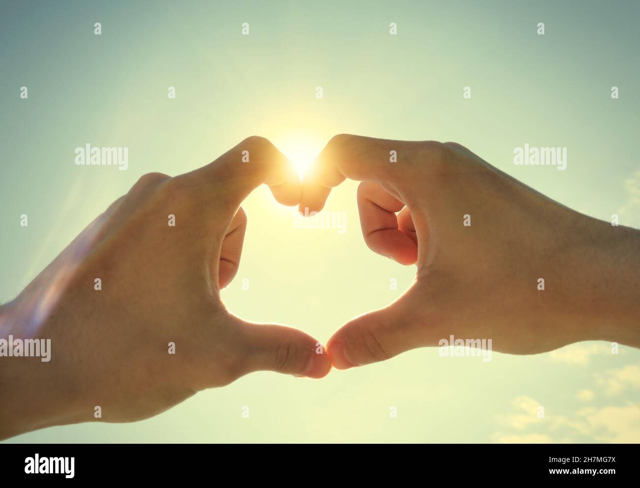 Toned Photo of Hands in Heart Shape on Sky Background Stock Photo - Alamy