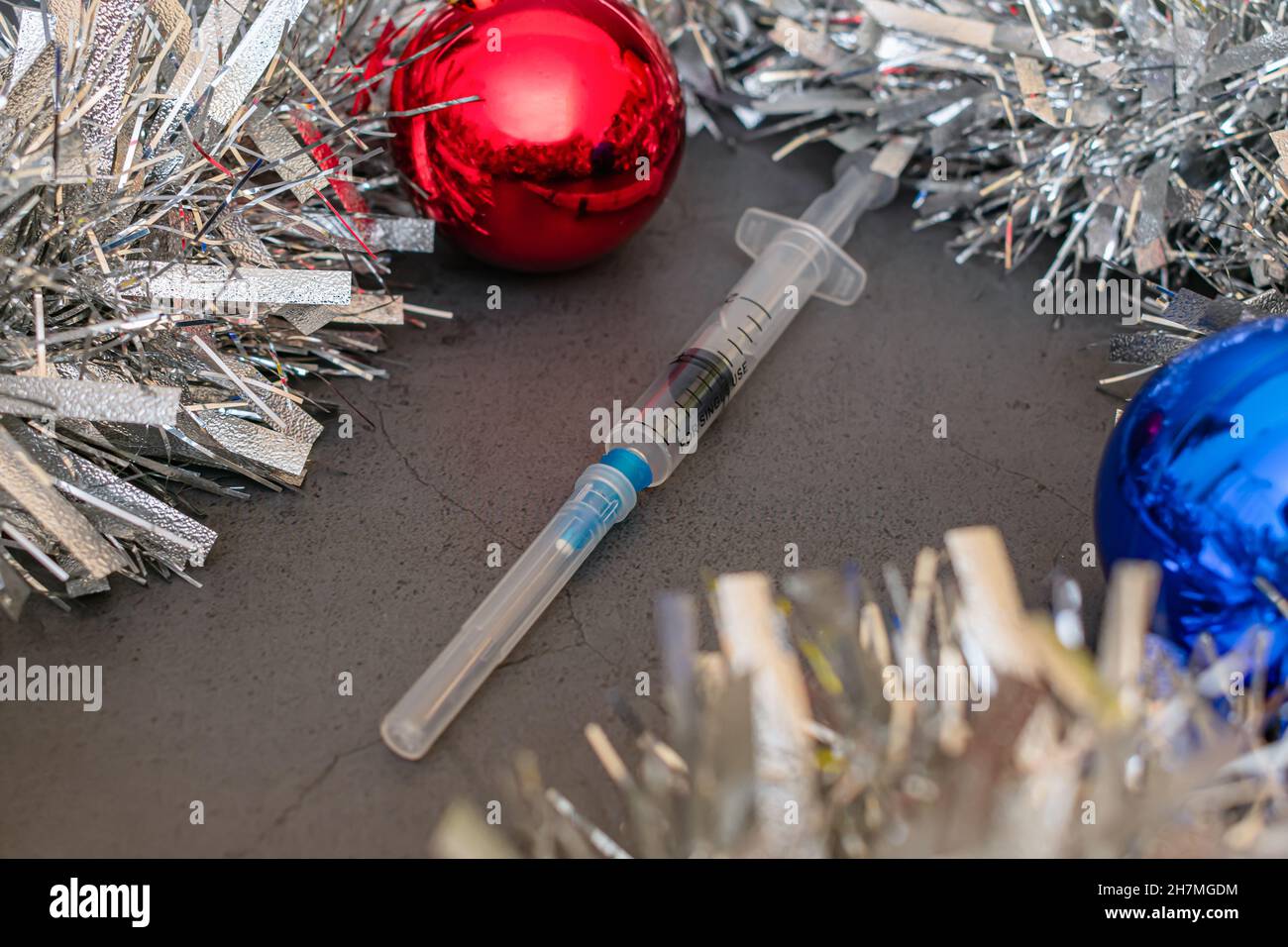 Christmas and New Year decorations and a syringe with a vaccine, modern ...