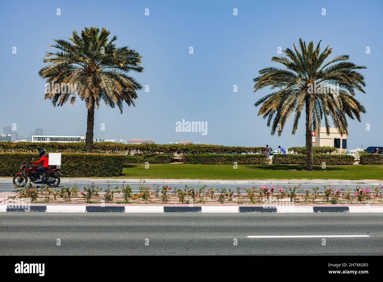 Asphalt road with modern city skyline of Dubai Stock Photo - Alamy