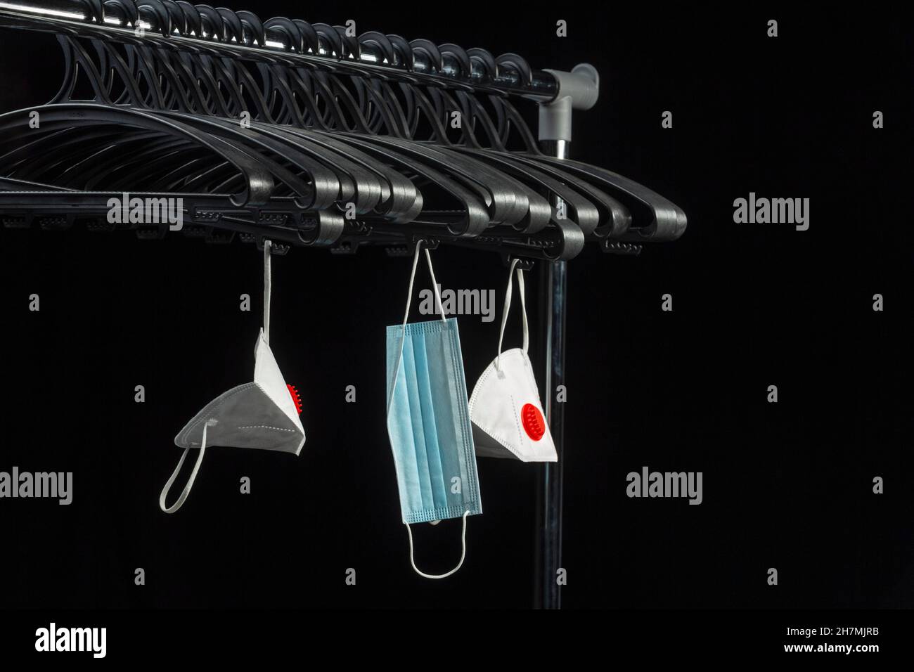 Protective COVID-19 face masks hanging from hangers Stock Photo - Alamy