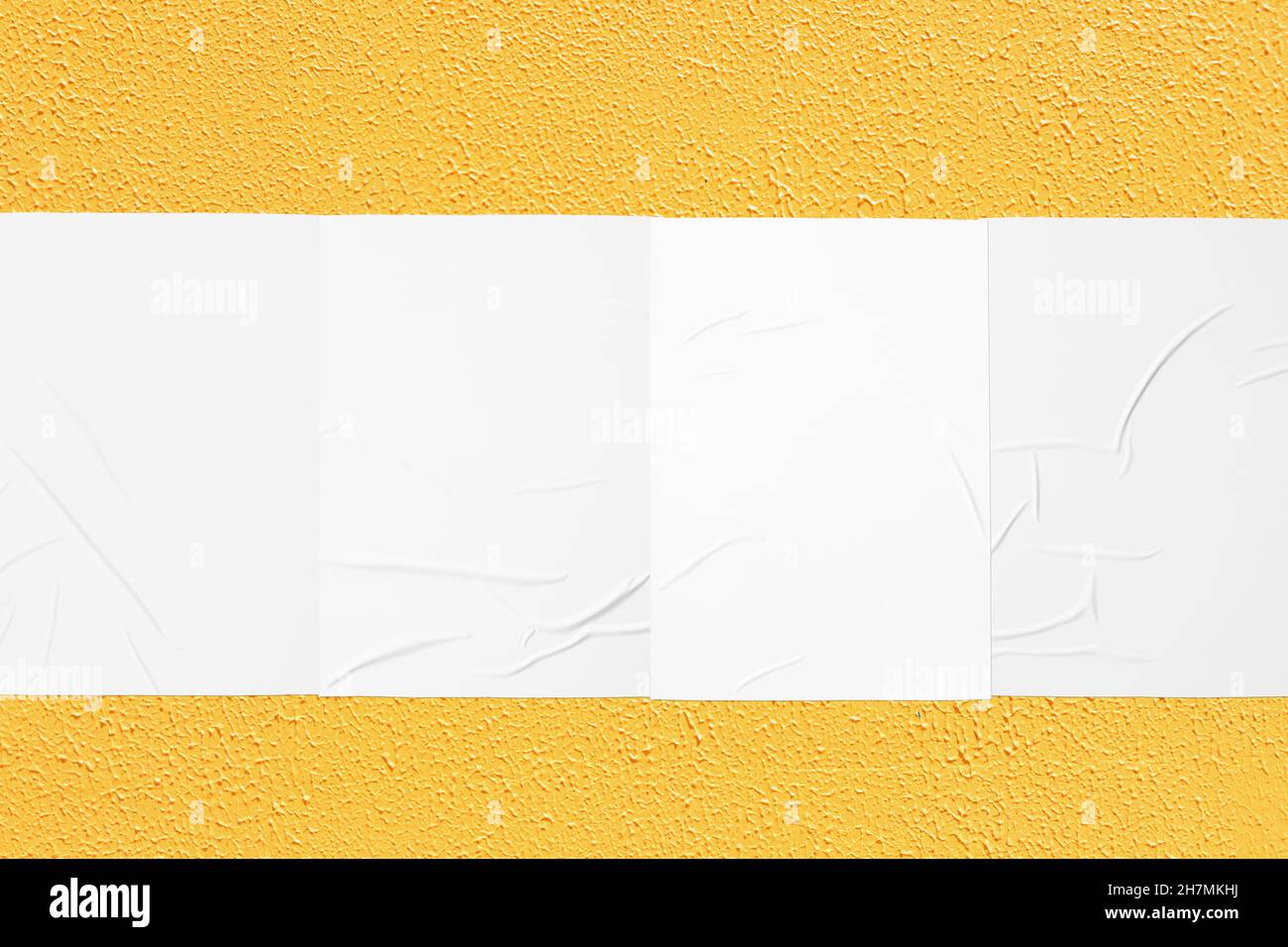 yellow urban wall texture with four wrinkled glued poster templates ...