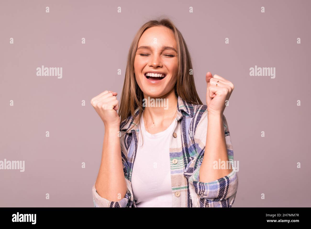 portrait of young woman winner against a white background Stock Photo ...