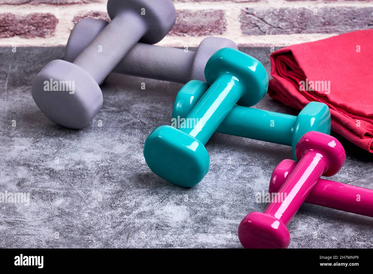 Variety of weights of different colors and weights on the floor of a ...
