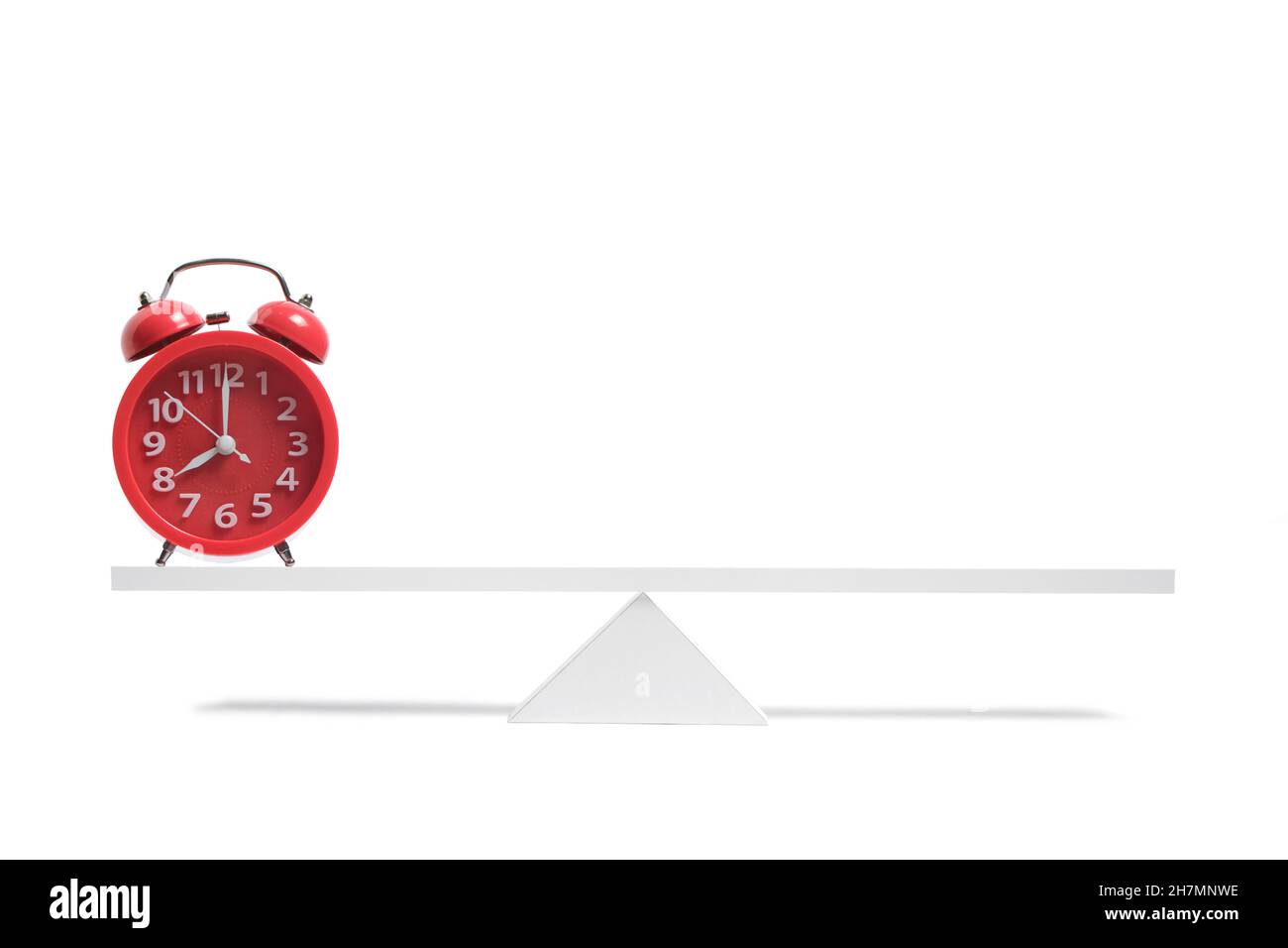 Red alarm clock stands on balanced scales, on a white background Stock ...