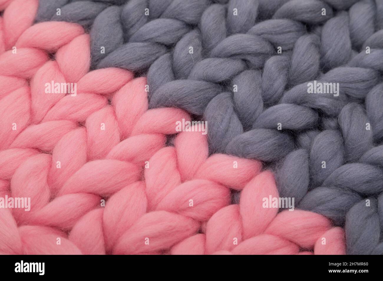a piece of a blanket made of natural wool of coral gray, coarse knit ...