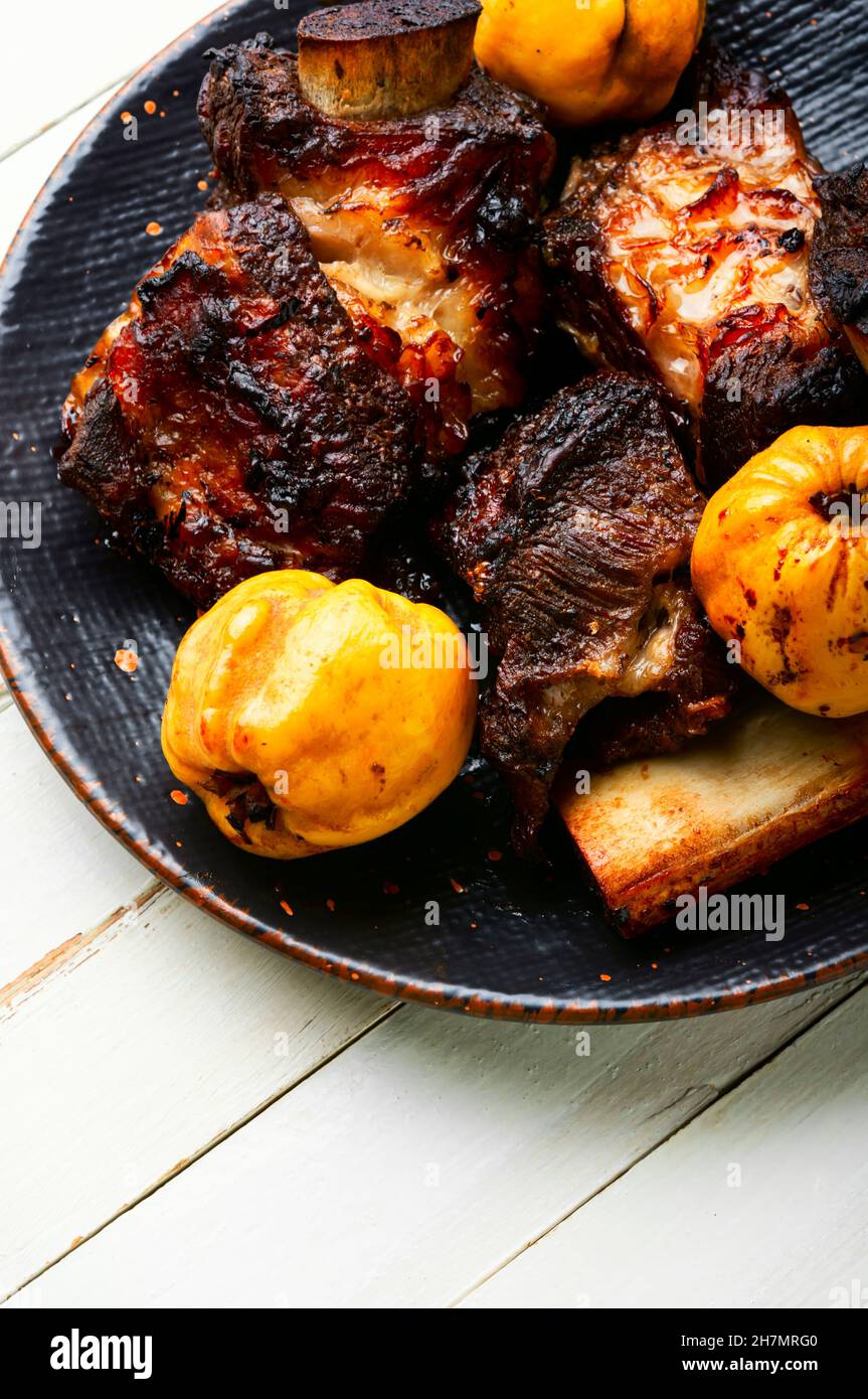 Succulent beef ribs fried with autumn quince Stock Photo - Alamy