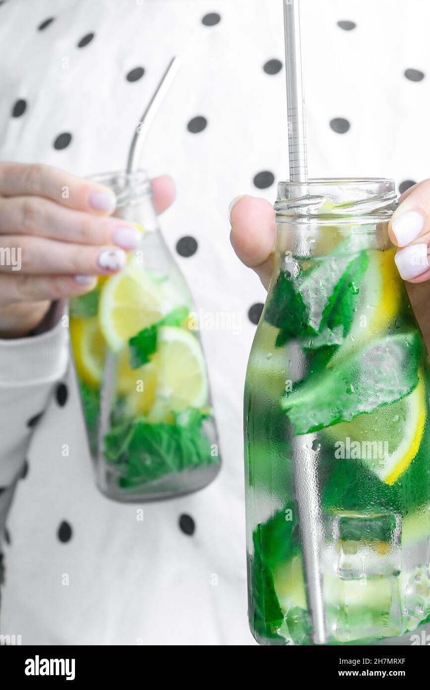 Female hand holding Mojito refreshing cocktail with eco metal drinking ...
