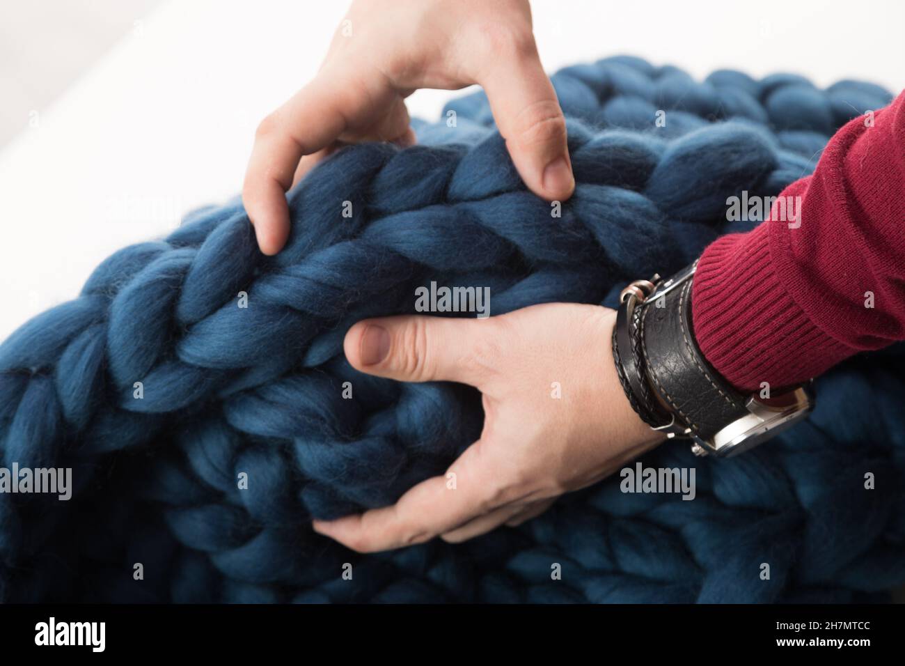 blanket made of natural sheep wool of coarse knit in men's hands Stock ...
