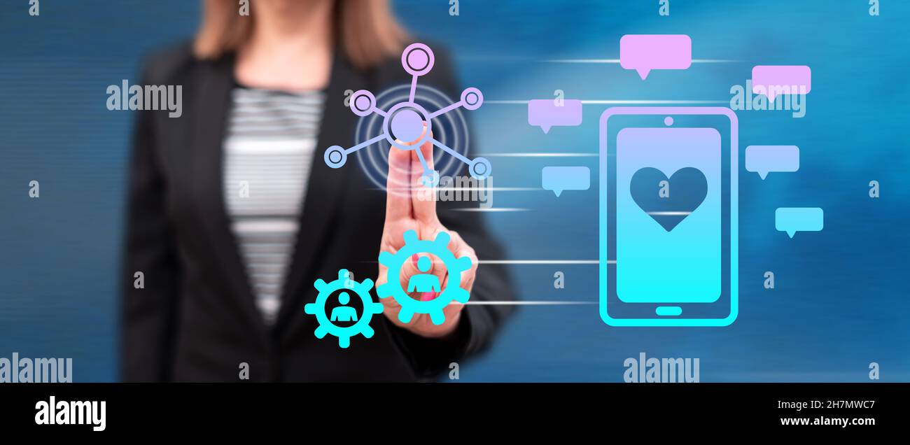 Woman touching a social networking concept on a touch screen with her ...