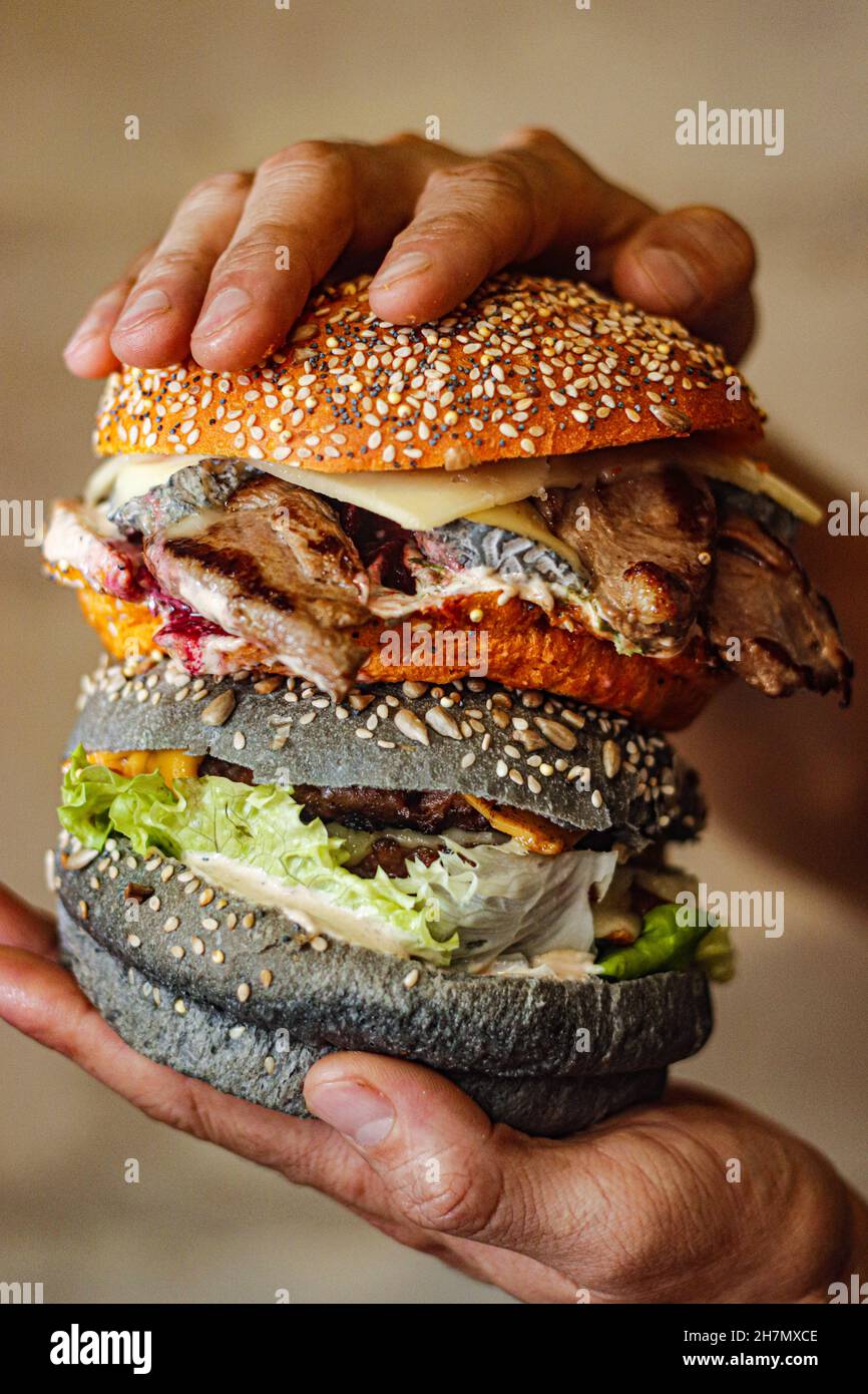 fat burger in hand Stock Photo - Alamy