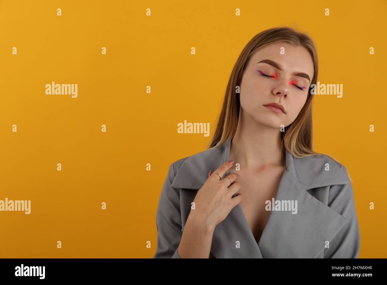 Beautiful model girl in autumn cloak on yellow background Stock Photo ...