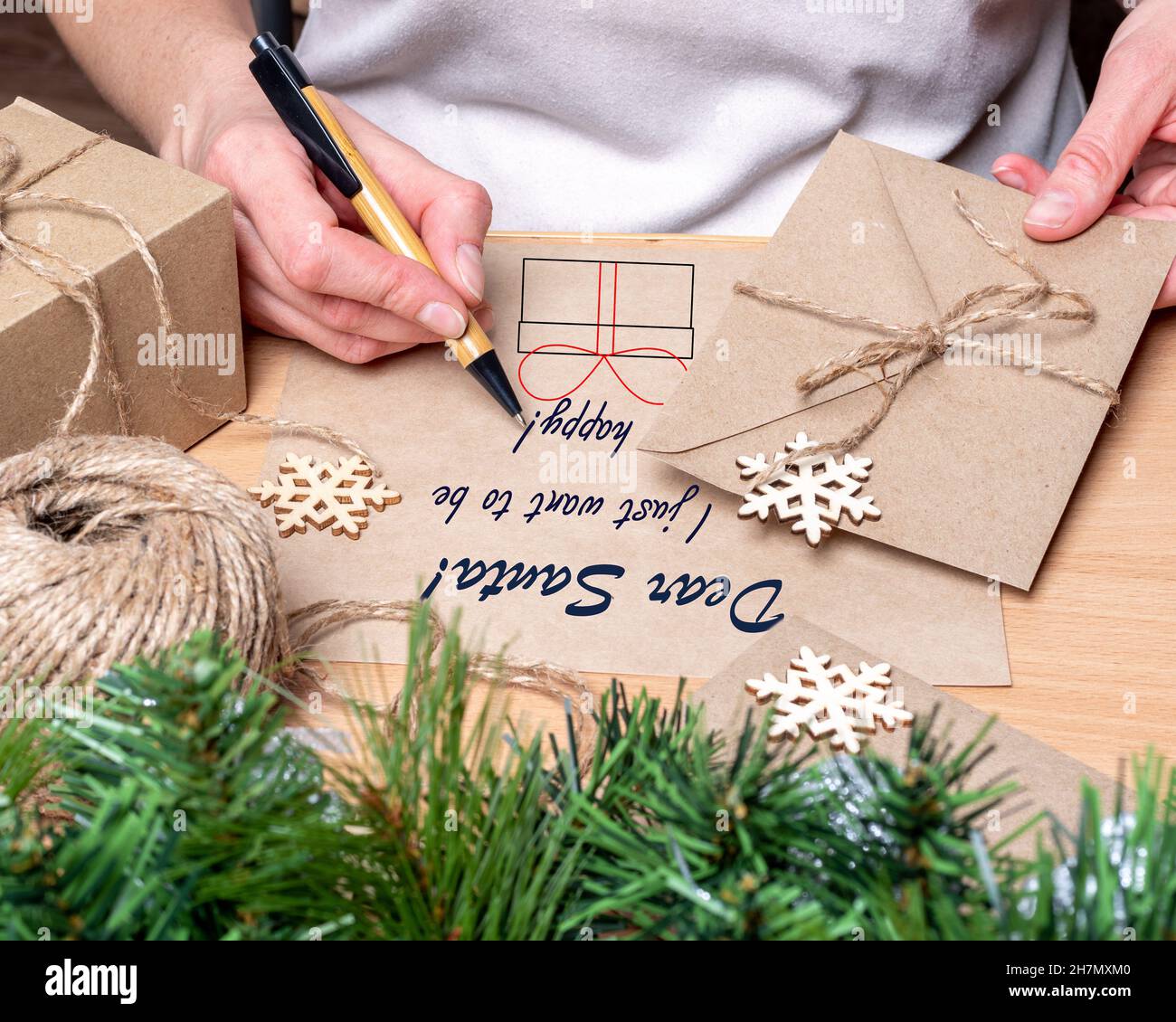 A woman asks Santa for Happiness. Female hand writing a Christmas ...