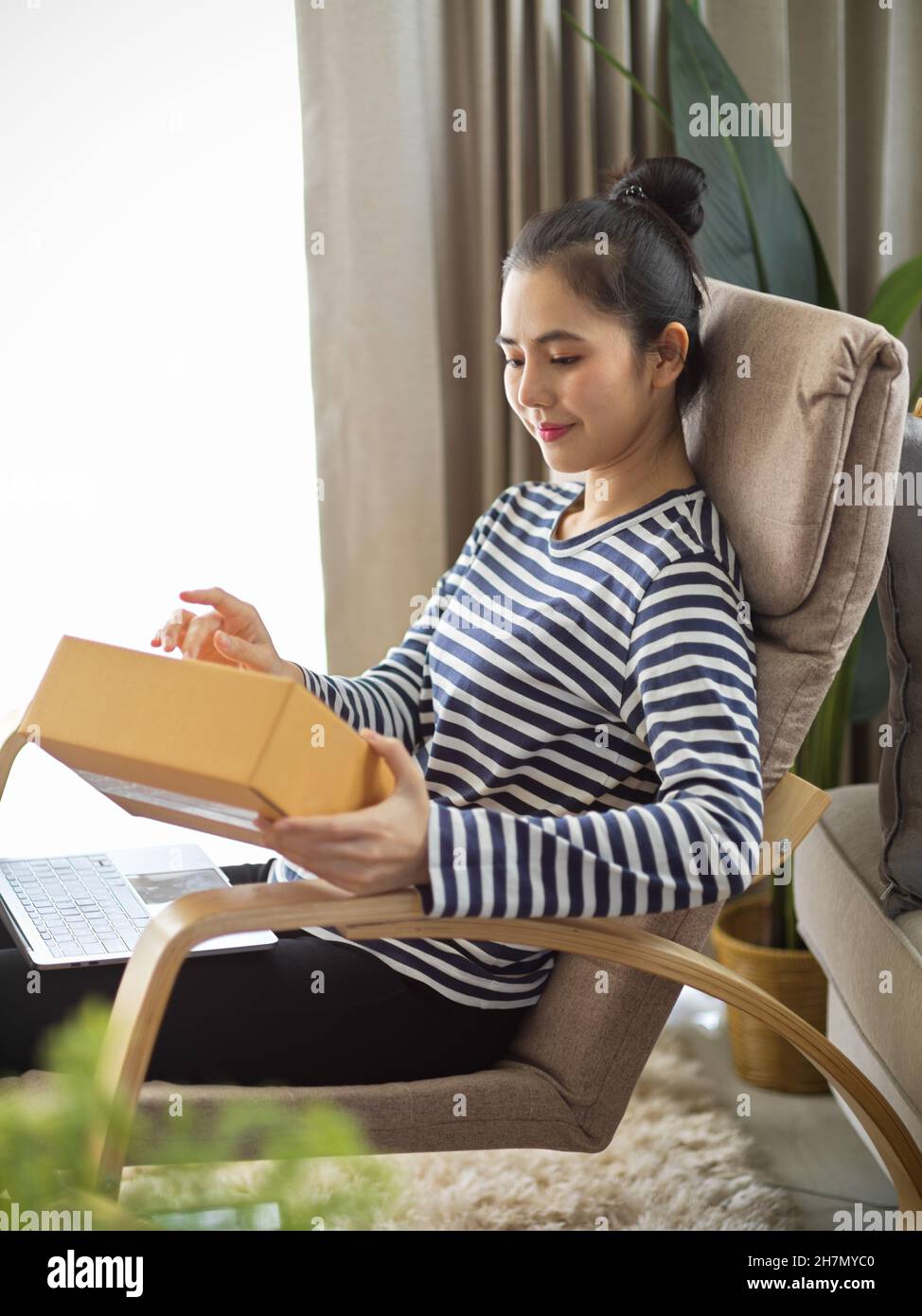 Beautiful woman receiving her package from an online shopping store ...