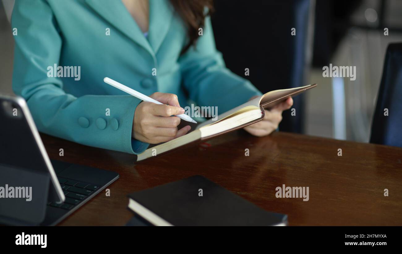 Woman reading a book while taking notes hi-res stock photography and ...