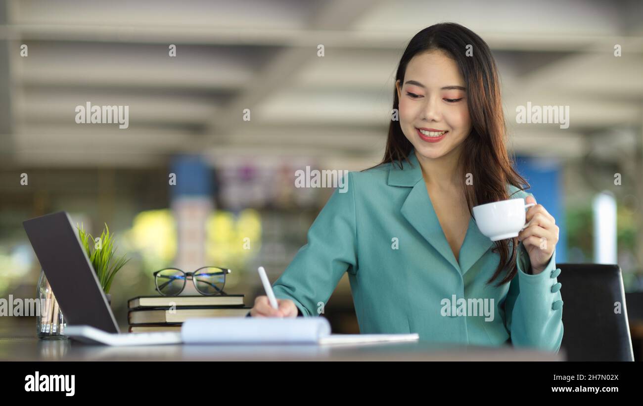 Asian female signing documents hi-res stock photography and images - Alamy