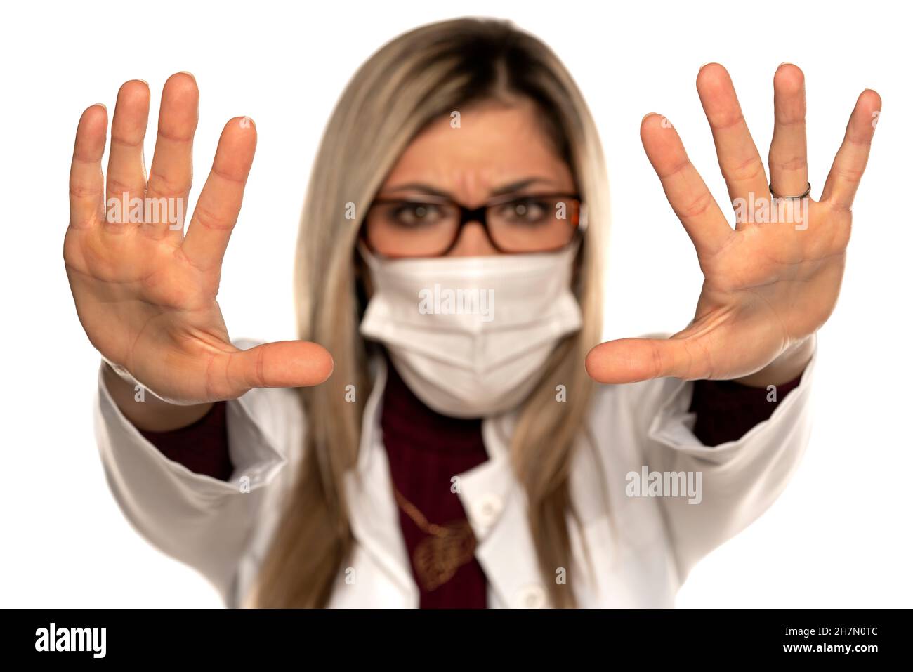 Young nervous female doctor with eyeglasses and face medical mask ...