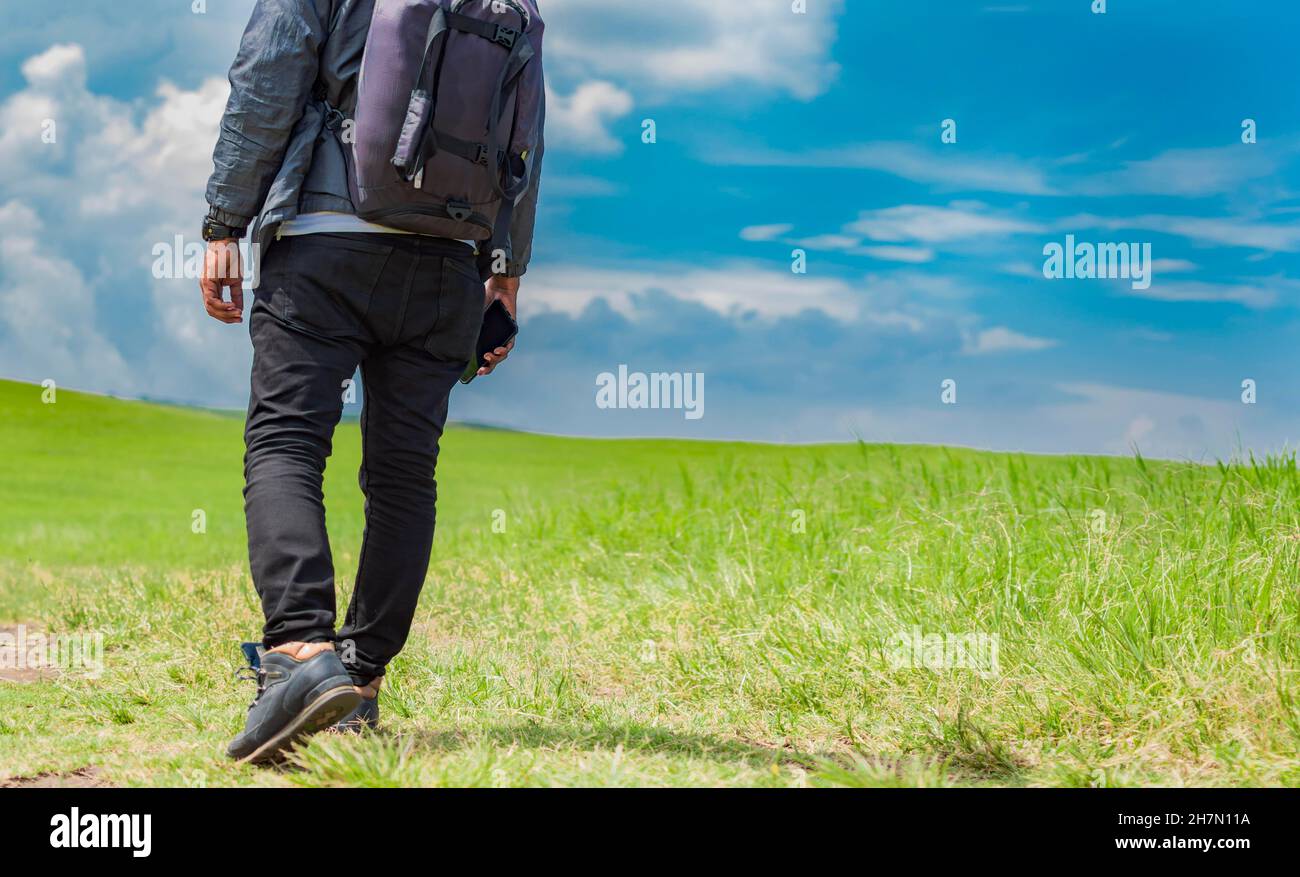 Adventurous man in the field, man with backpack in the field looking ...