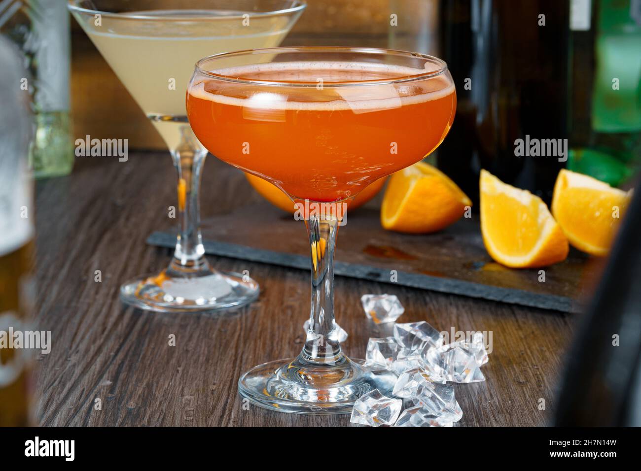 Two beautiful cocktails served on a wooden bar counter Stock Photo - Alamy