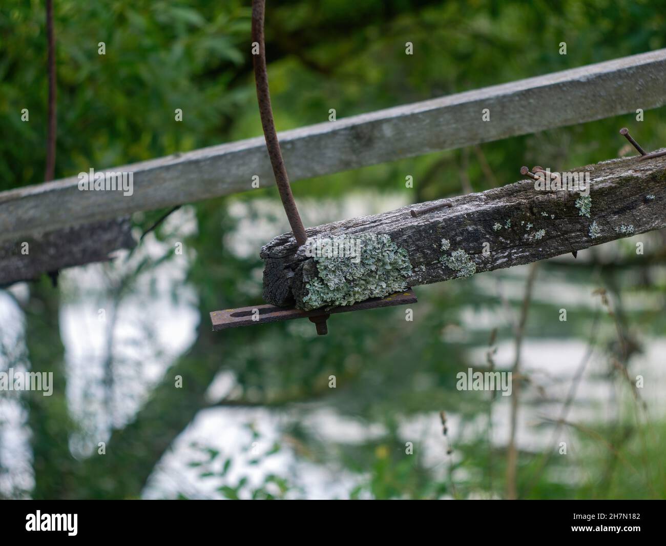 a collapsed wooden pedestrian bridge over the river, in summer Stock ...