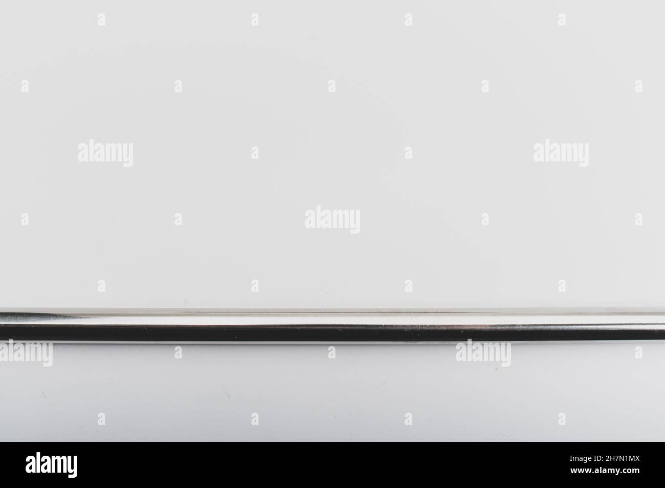 shiny metal tube close up on a white background with space for text ...