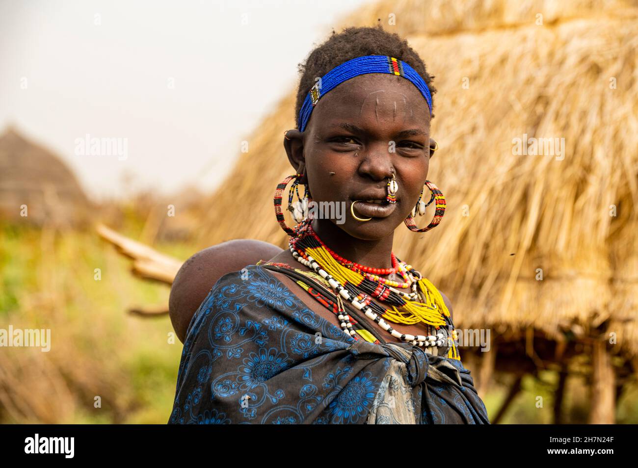 Woman with her child before her hut, Jiye tribe, Eastern Equatoria ...