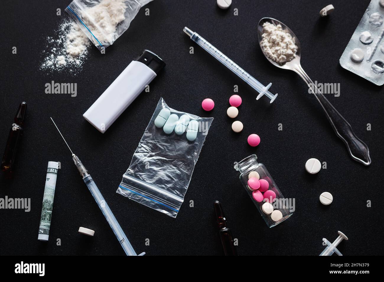 drugs powder and pills on black background Stock Photo - Alamy