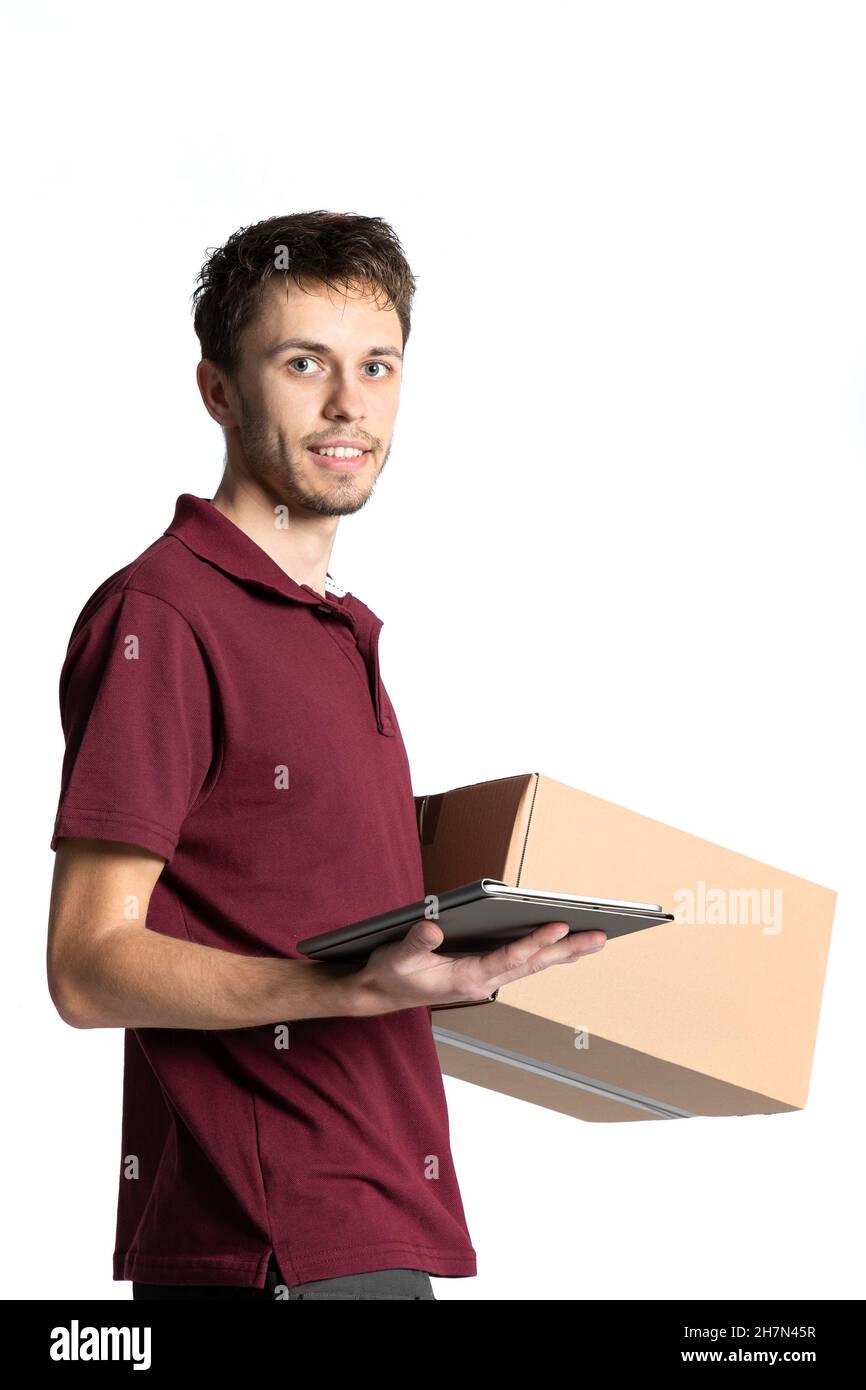 Smiling delivery man holding pile of cardboard boxes on a white ...
