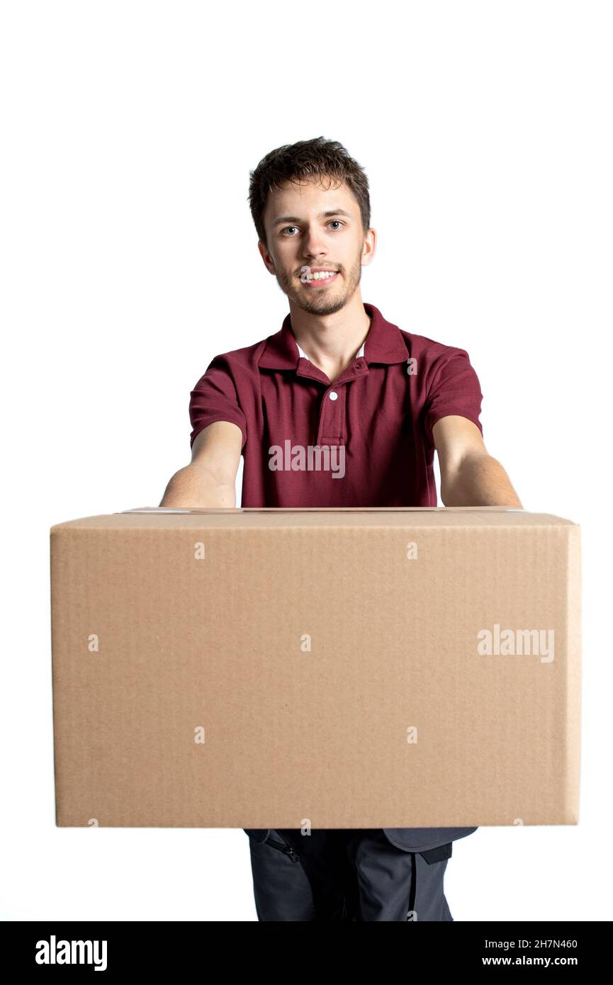 Smiling delivery man holding pile of cardboard boxes on a white ...