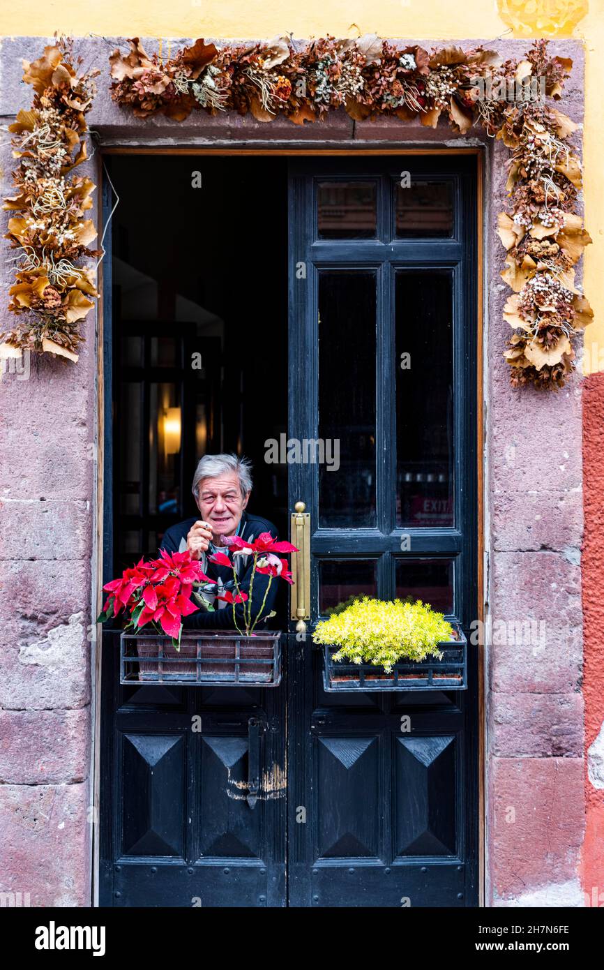Man smoking in a window, Unesco site San Miguel de Allende, Guanajuato ...