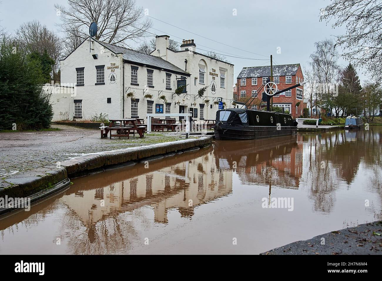 A winter scene of the Shroppie Fly pub and one narrowboat at Audlem on ...