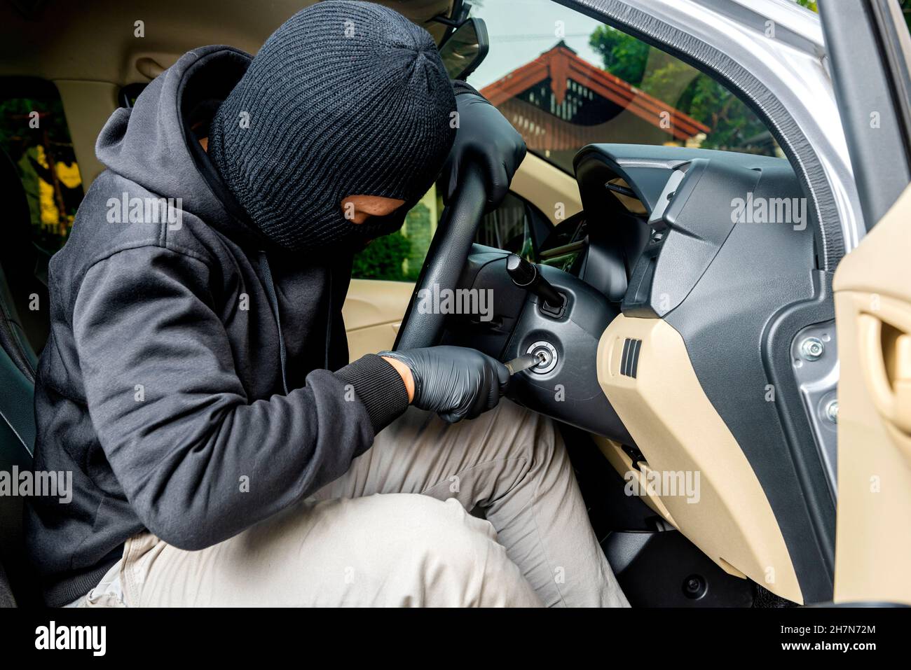 Car thief man trying to steal the car on the street Stock Photo - Alamy