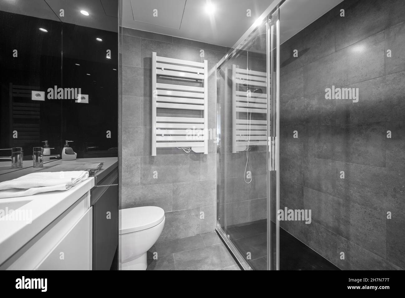 Shower enclosure with radiator on the wall of a bathroom with glossy ...